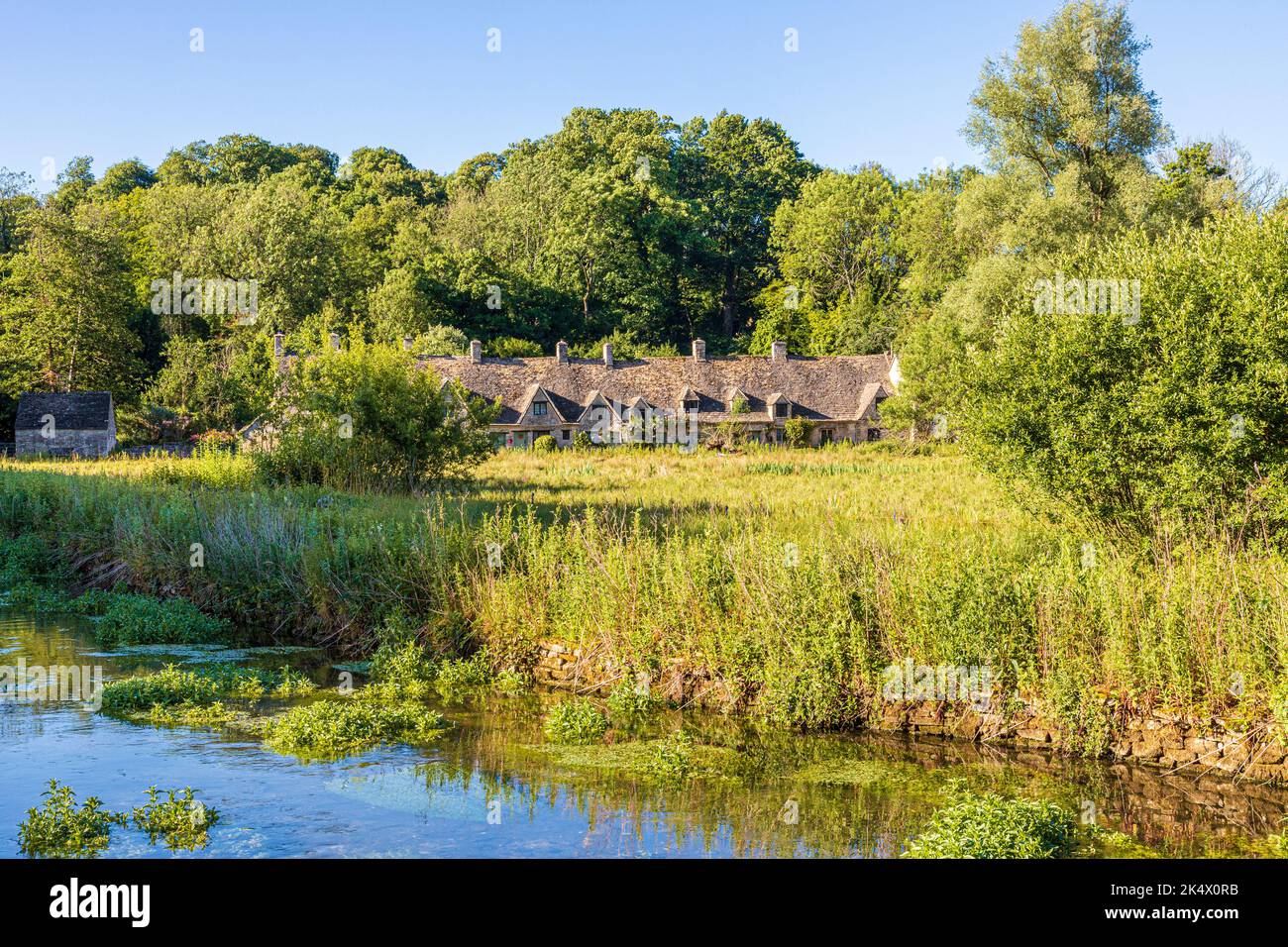 Early morning light in midsummer on Arlington Row beside the River Coln ...