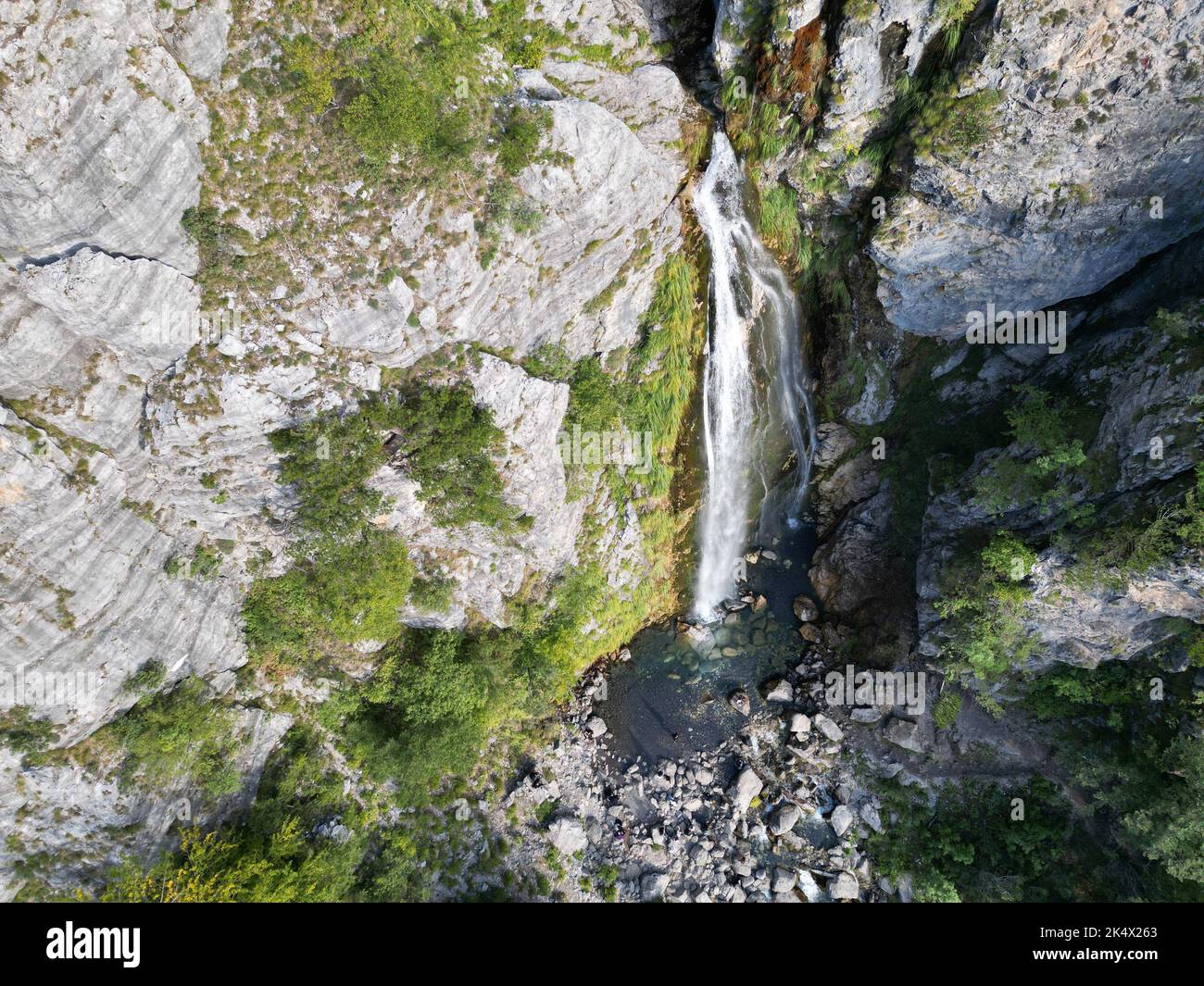A bird's eye view of the narrow waterfall between rocky formations ...