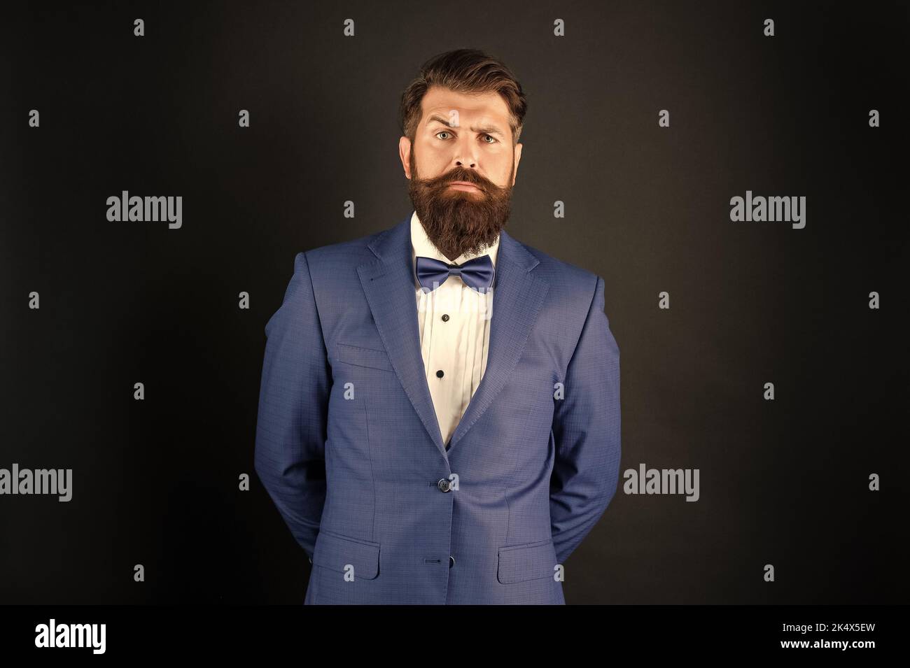 serious man in tuxedo bow tie. gentleman in formalwear on black ...