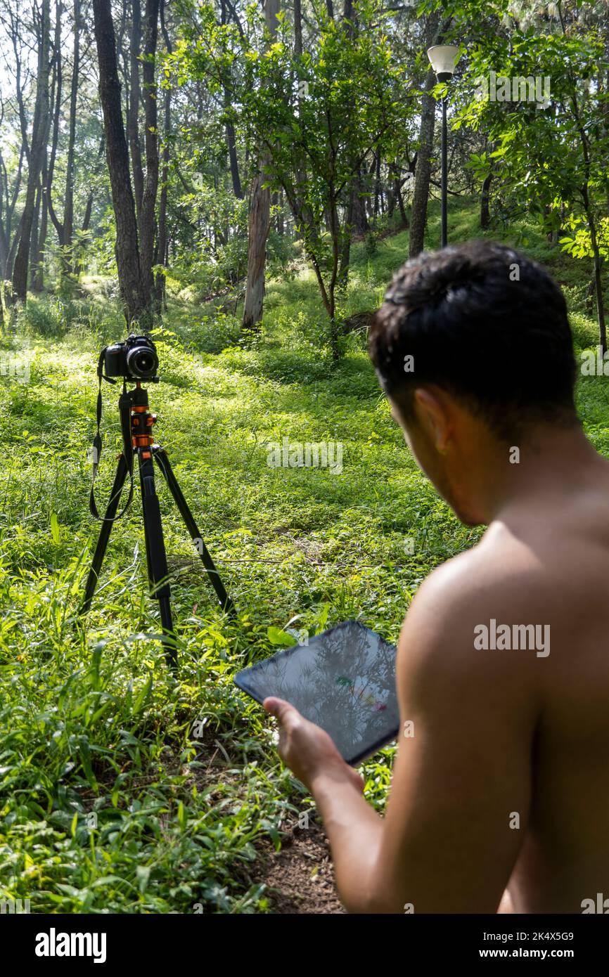young man explaining drawing on his tablet, while teaching chakra, yoga ...