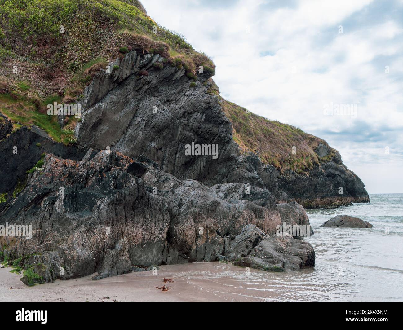 Sheer cliffs at Warren Beach. Beautiful sky. The picturesque coast ...