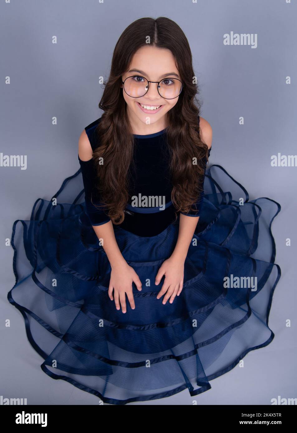 Elegant teenager child girl in fashion dress. Girl dressed in ball ...
