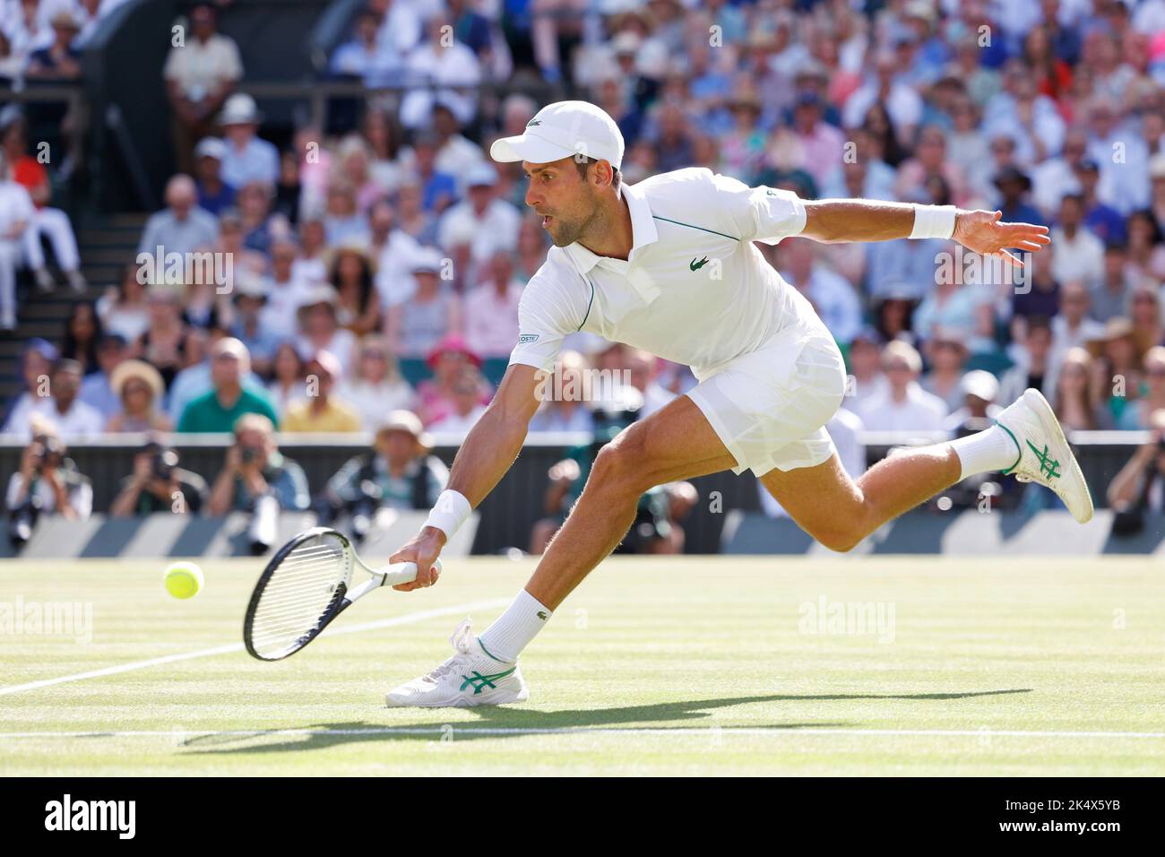 Serbian tennis player Novak Djokovic playing backhand shot during 202 Wimbledon Championships ...