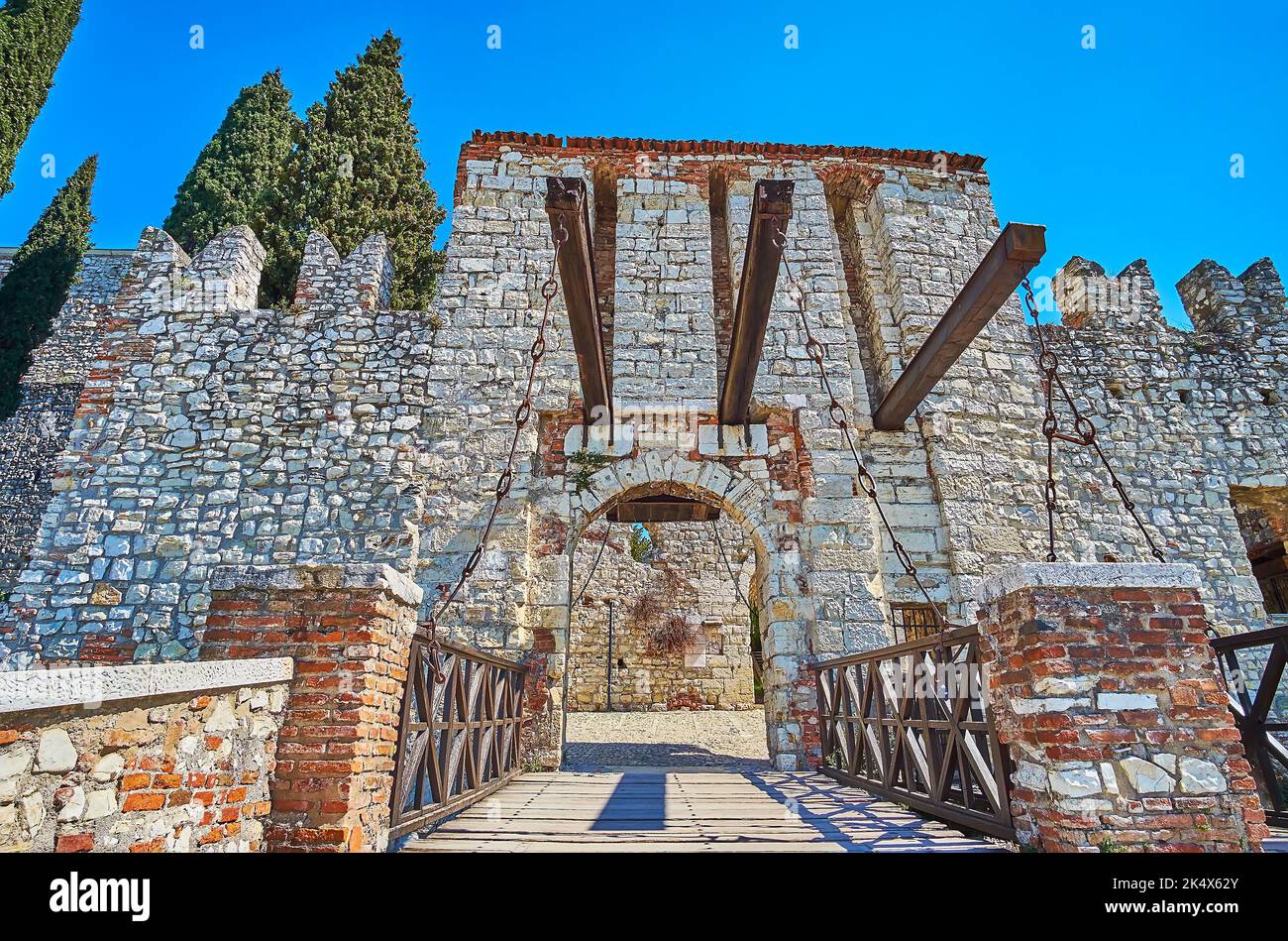 The medieval stone gate of Castello di Brescia with tall wall and ...