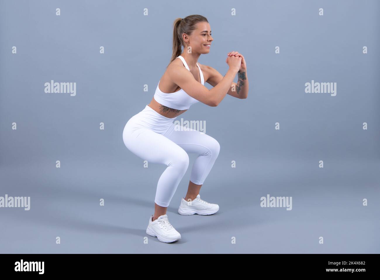 Beautiful strong happy cheerful sports woman posing on isolated ...