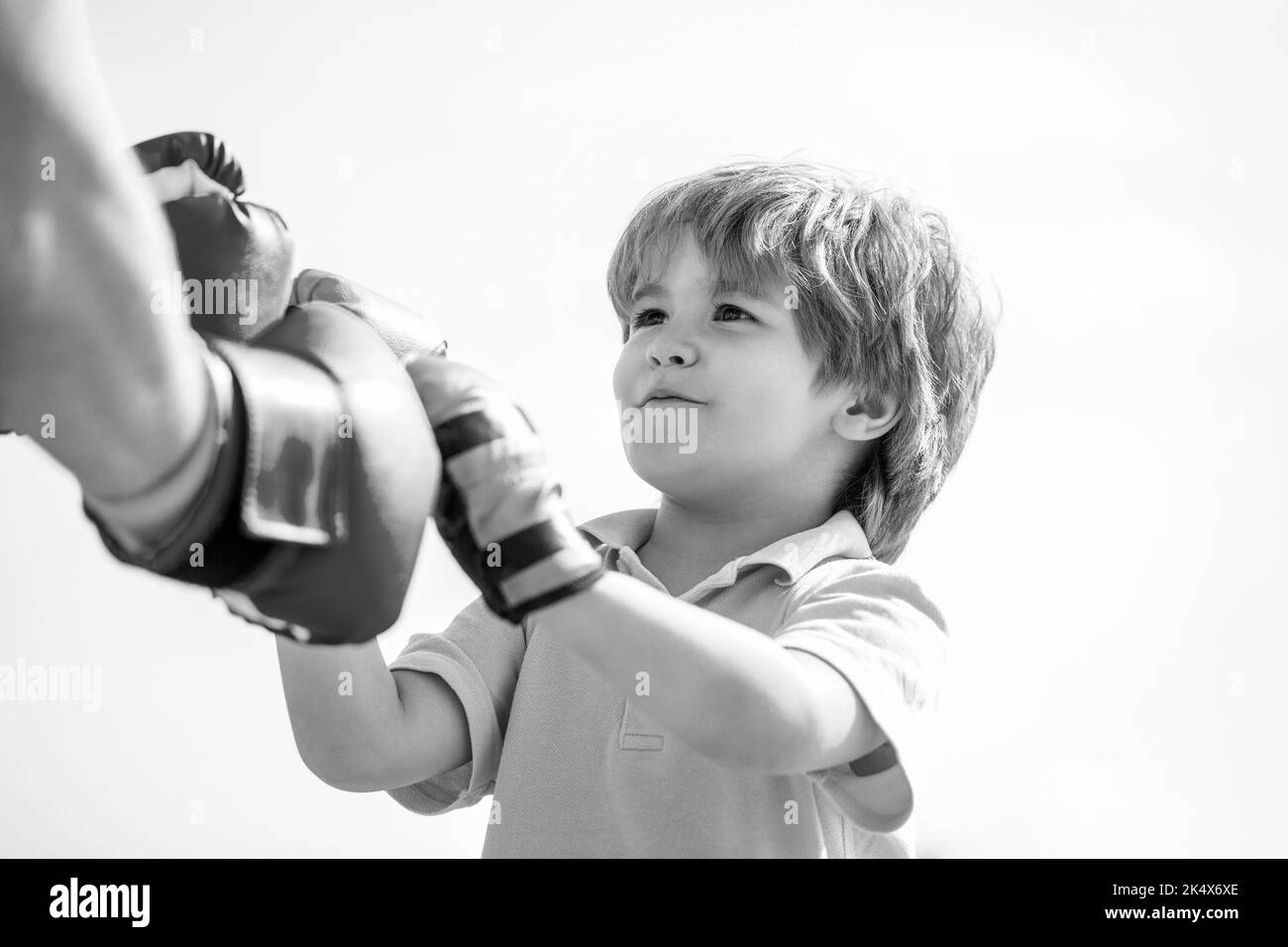 Father is training his son boxing. Little boy doing boxings exercise ...