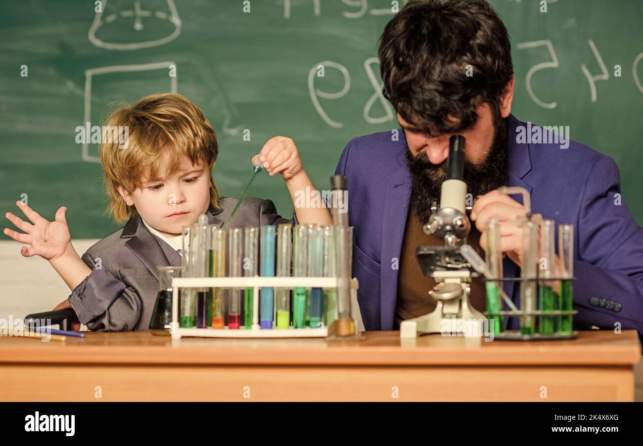 microscope. bearded man teacher with little boy. laboratory research ...