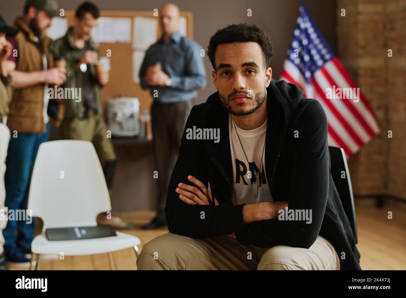 Young unhappy man with post traumatic syndrome looking at camera while ...