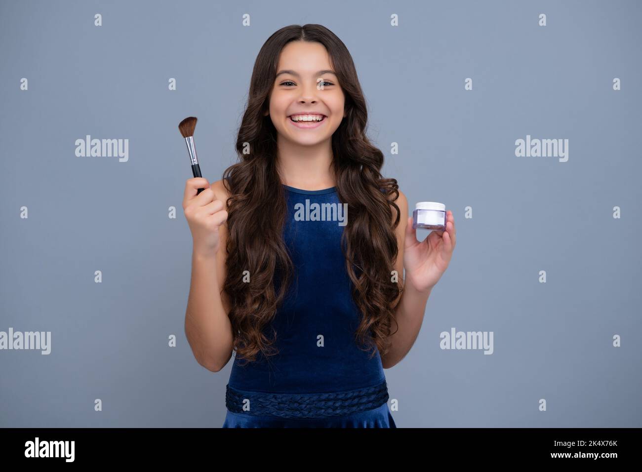 Kids make up products. Makeup teen child artist apply face powder with ...