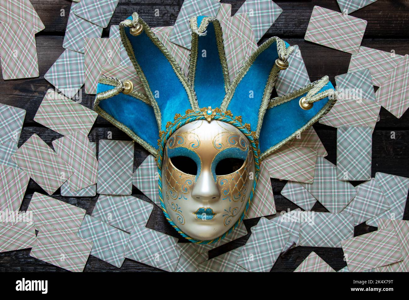 The Venetian mask lies on a wooden table on the cards, theatrical mask ...