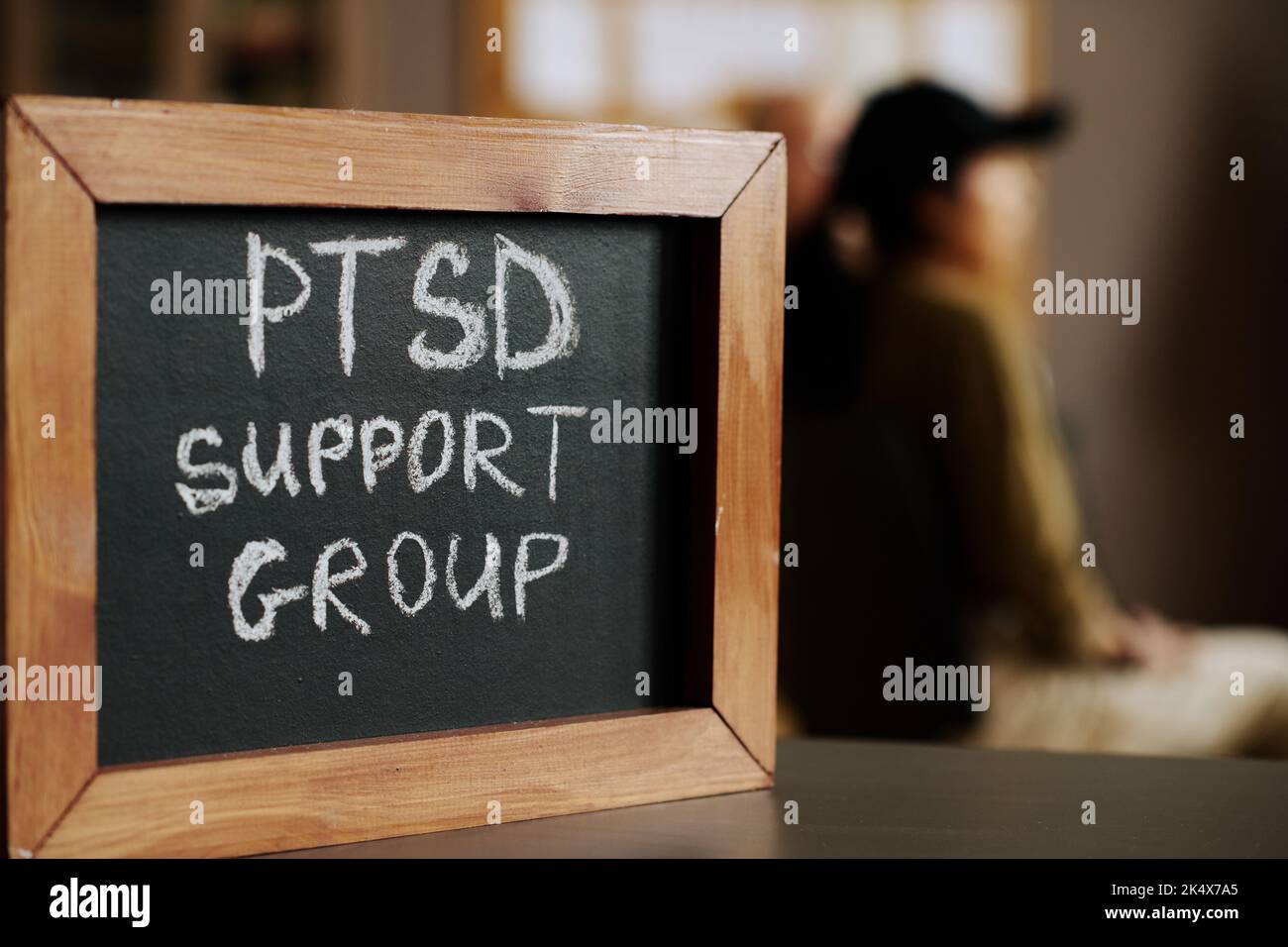 Small chalkboard with name of psychological support group or course in ...