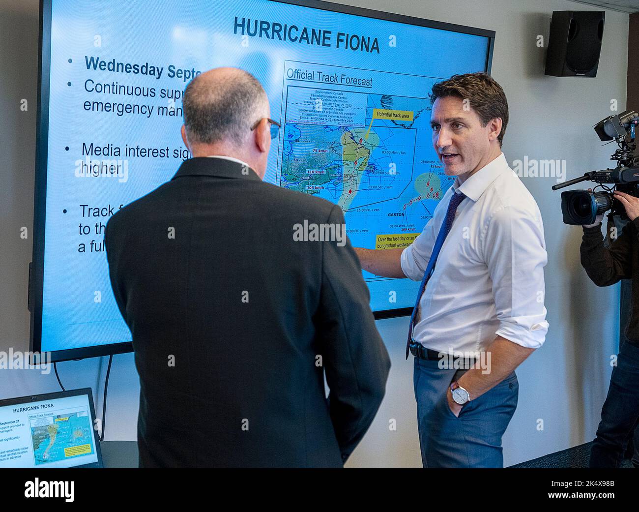 Prime Minister Justin Trudeau talks with Bob Robichaud, a meteorologist ...