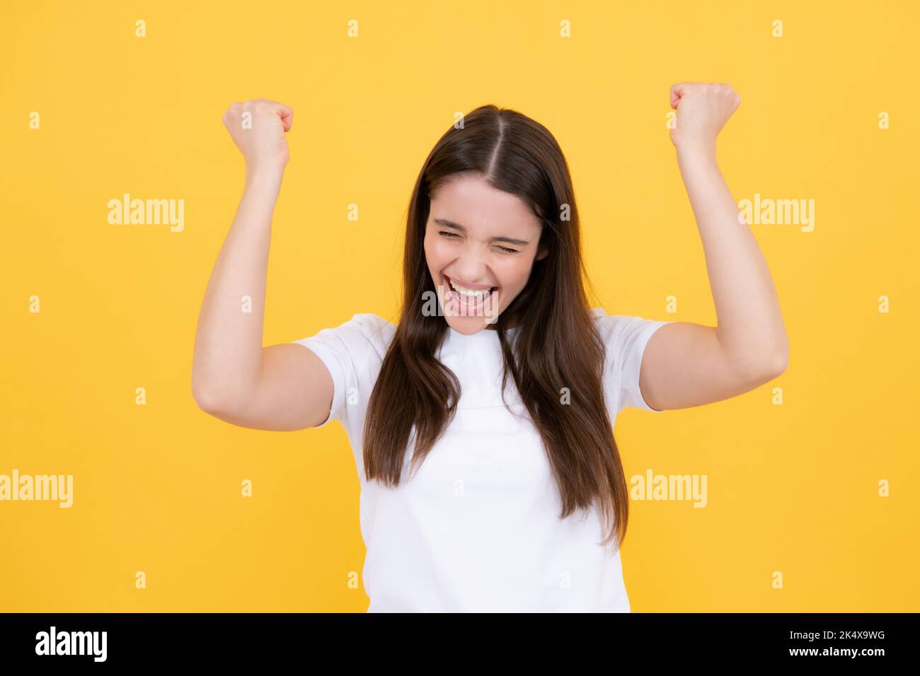 Cheerful beautiful young woman showing winner gesture. Excited female ...