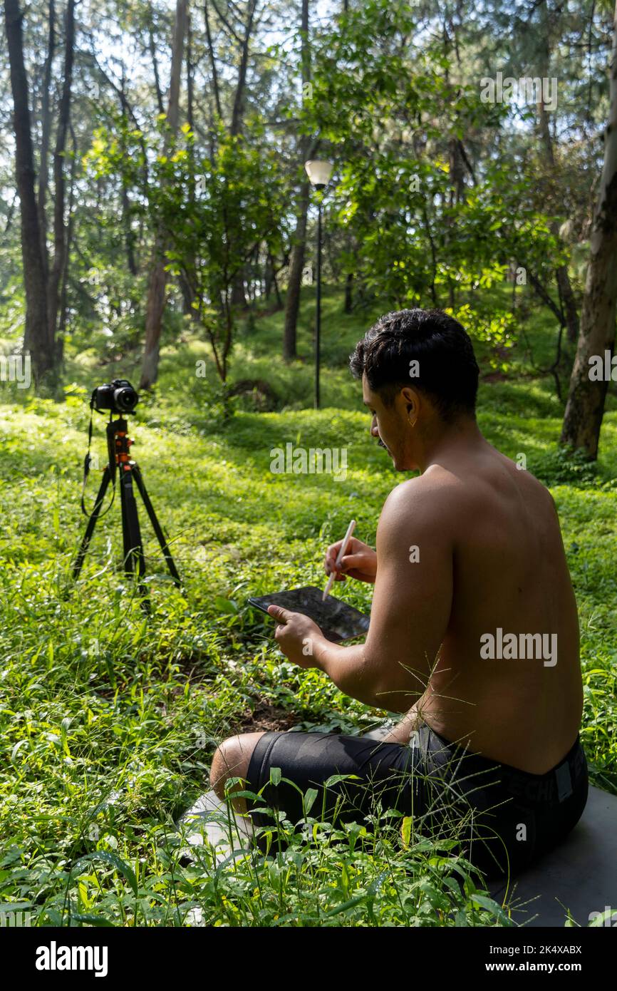 hispanic latino man giving class, while being recorded by a camera ...