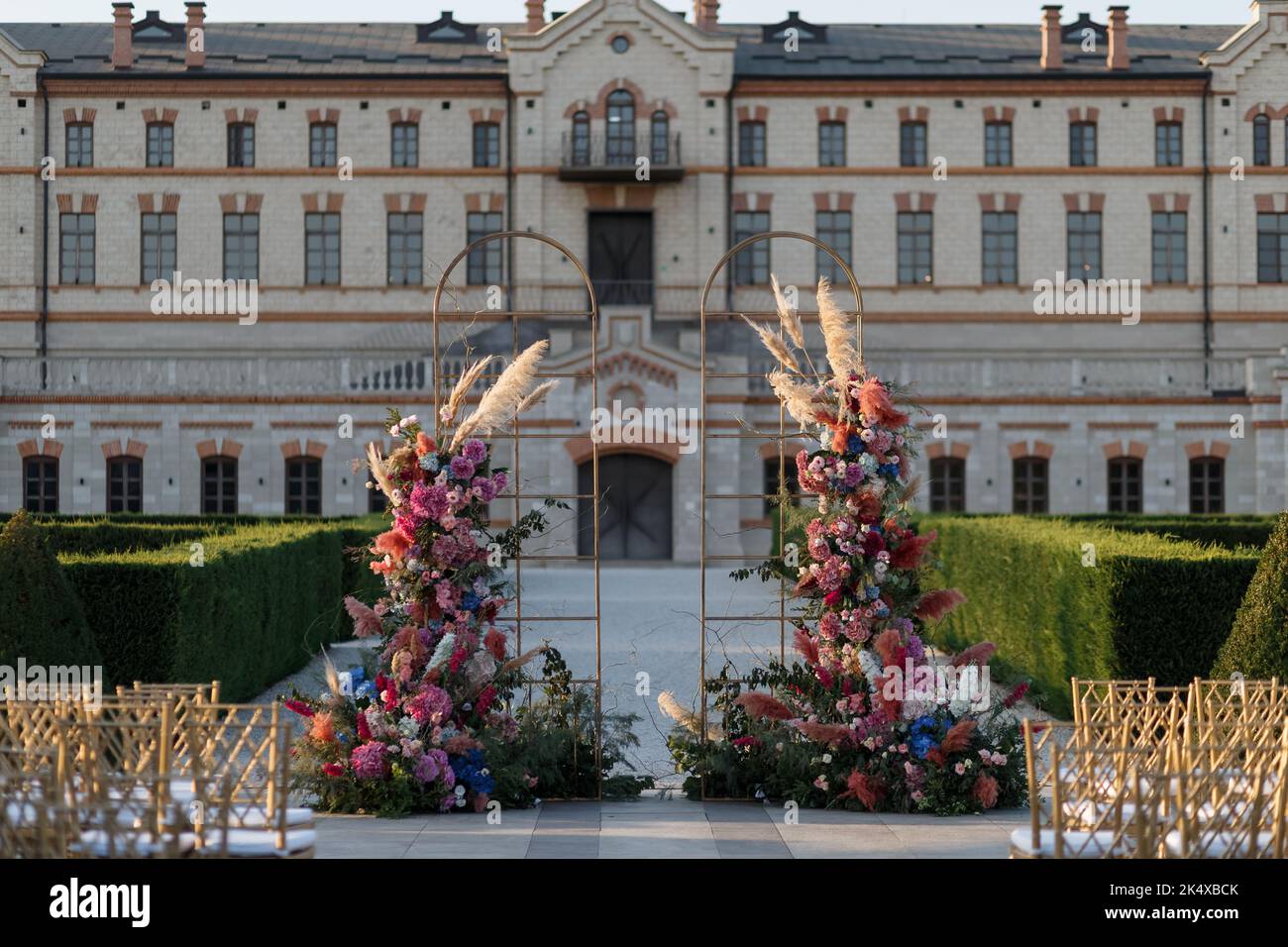 Floral Wedding Arch set up at Palace Mimi with gold chairs front view ...
