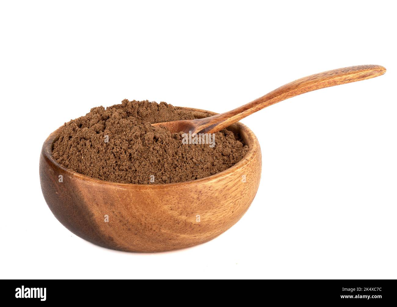 Ground cinnamon powder in a wooden bowl on a white background. Copy ...