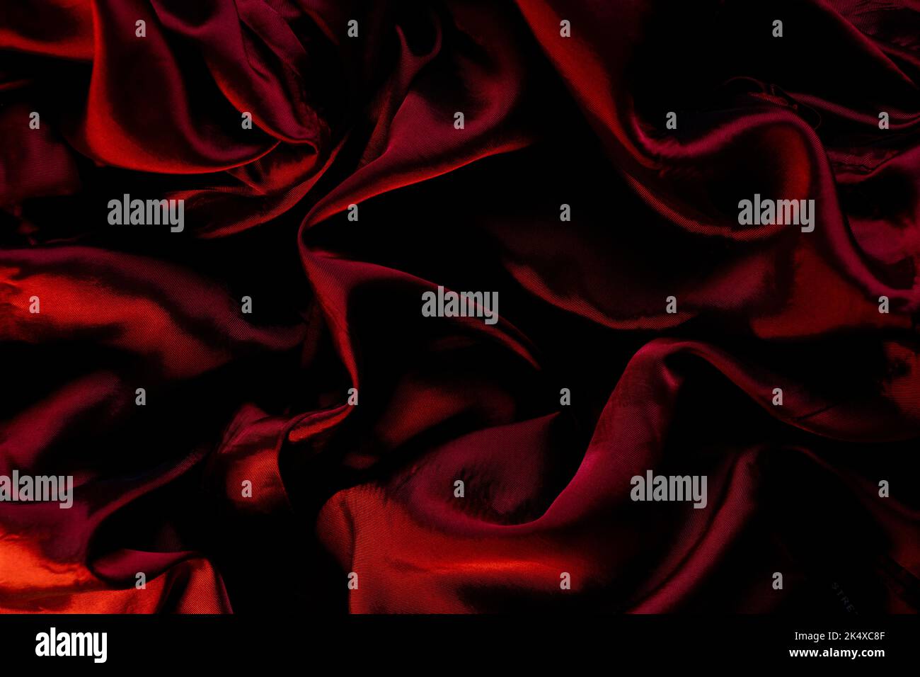 Red wavy fabric as a background, red background Stock Photo - Alamy