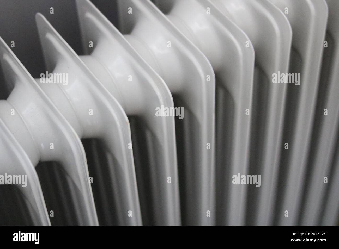 Full frame background of old fashioned grey metal radiator showing fin ...