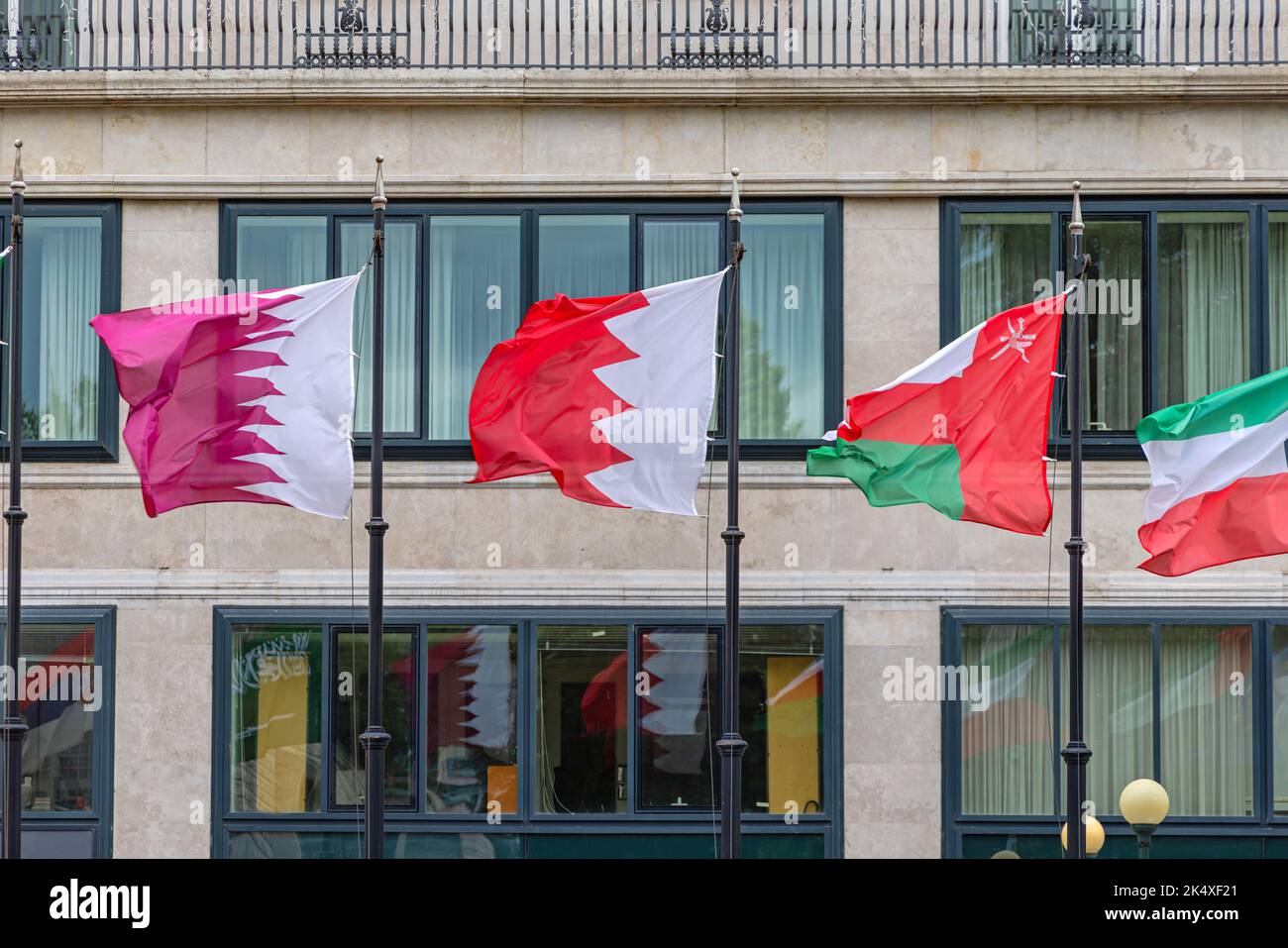 Qatar Bahrain Oman Flags in Front of Hotel Building Middle East Stock ...