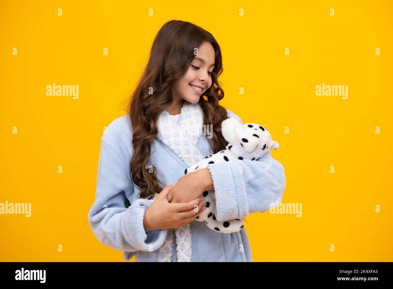 Child in pajamas, good morning. Teenager girl hold soft toy for ...