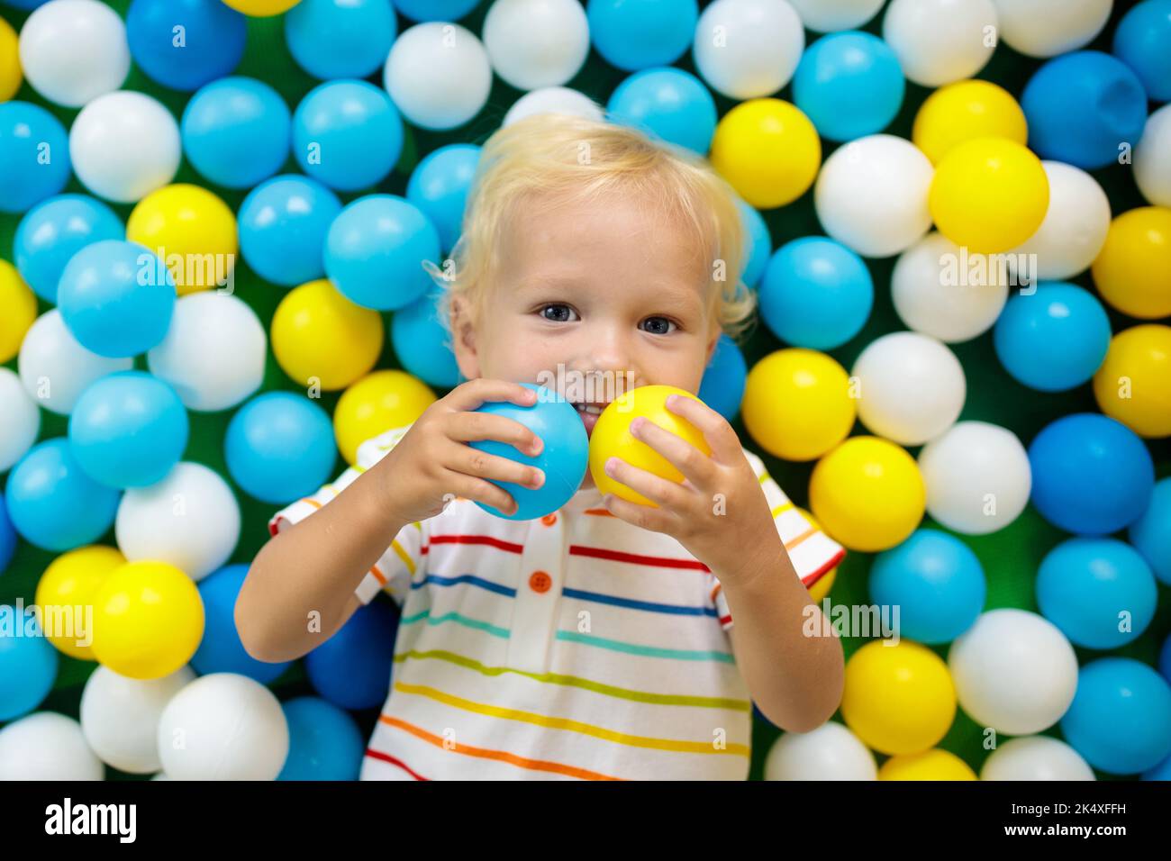 Child playing in ball pit. Colorful toys for kids. Kindergarten or ...