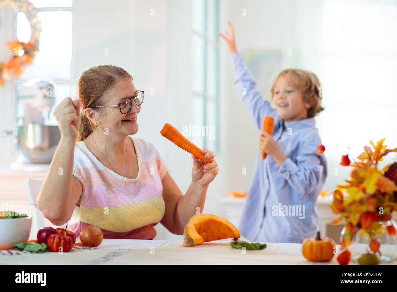 Family cooking Thanksgiving dinner pumpkin pie. Mother and child dance ...