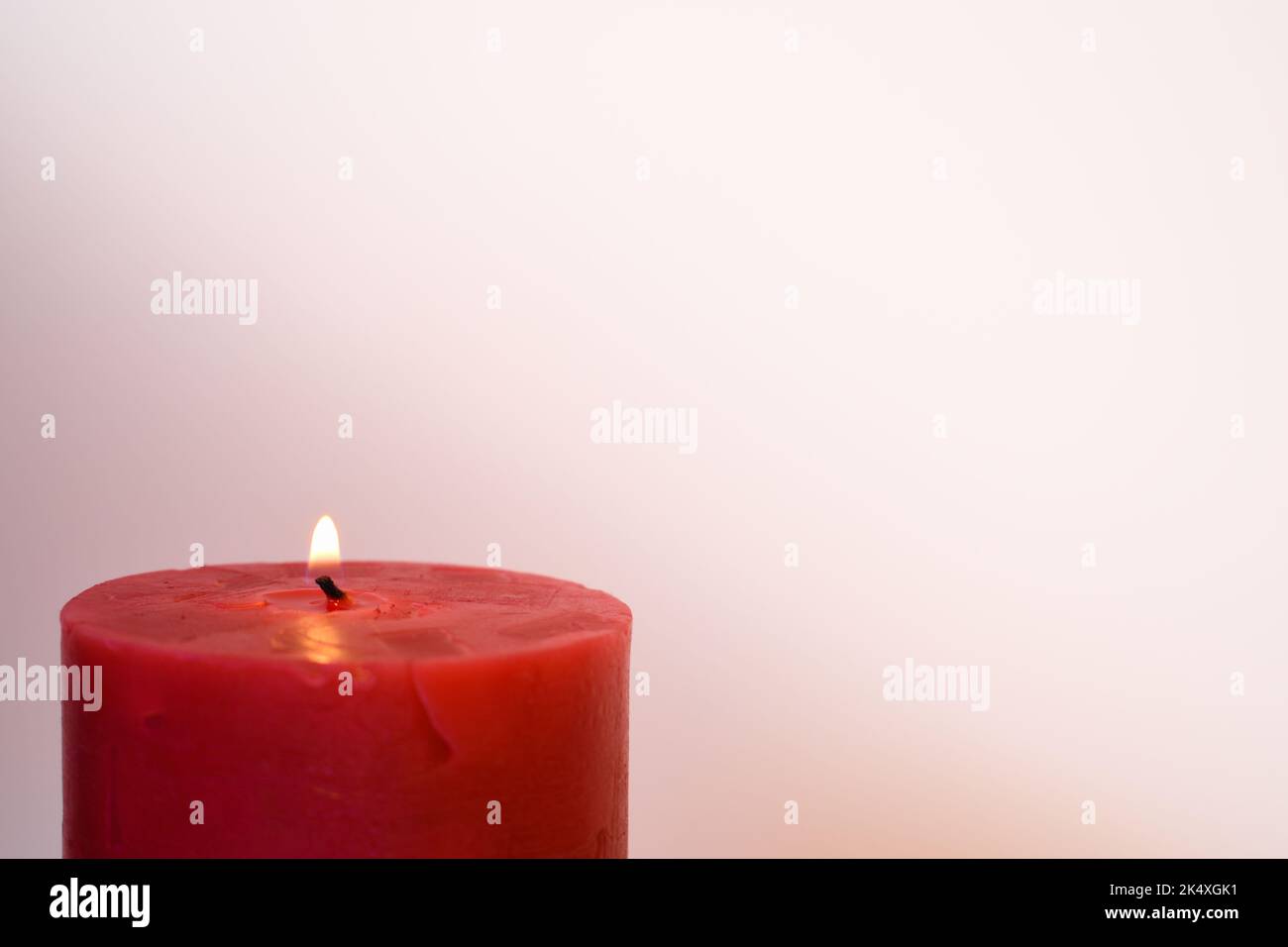 Candlelight on a red candle, white background Stock Photo - Alamy