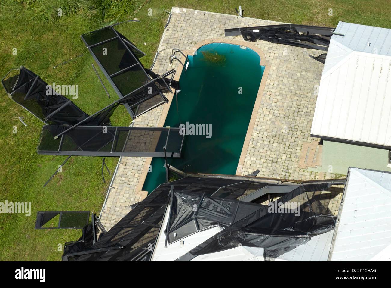 Hurricane Ian destroyed swimming pool lanai enclosure on house yard in ...