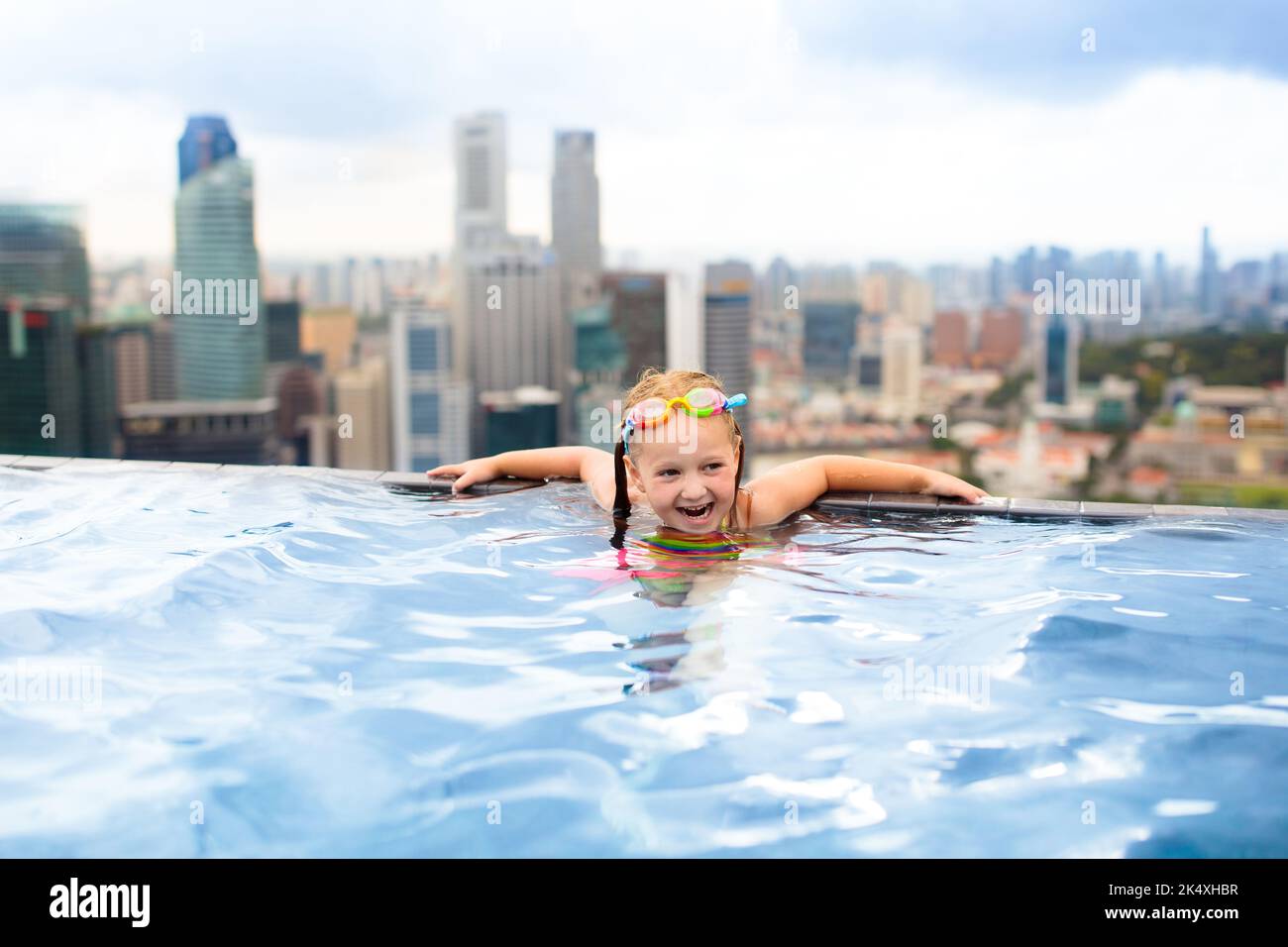 Children swimming in an infinity pool hi-res stock photography and ...