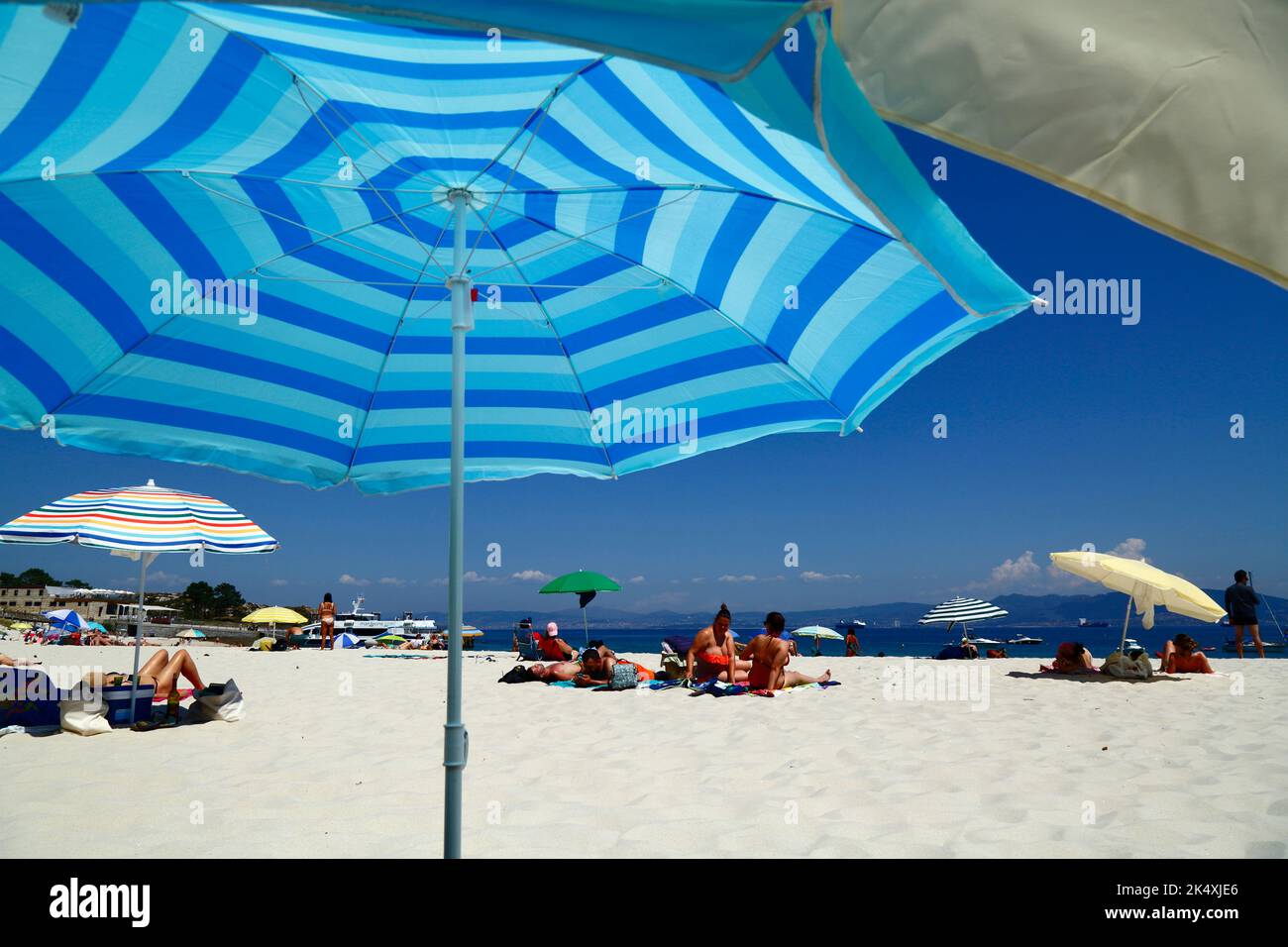 Sun parasols and tourists on the famous Playa de Rodas beach on the ...