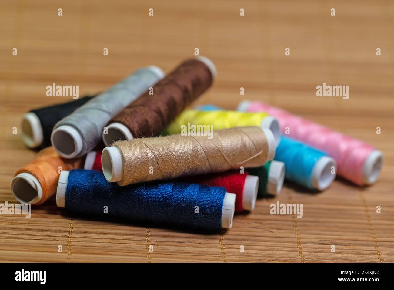 Sewing thread, spools of thread in different colors Stock Photo - Alamy