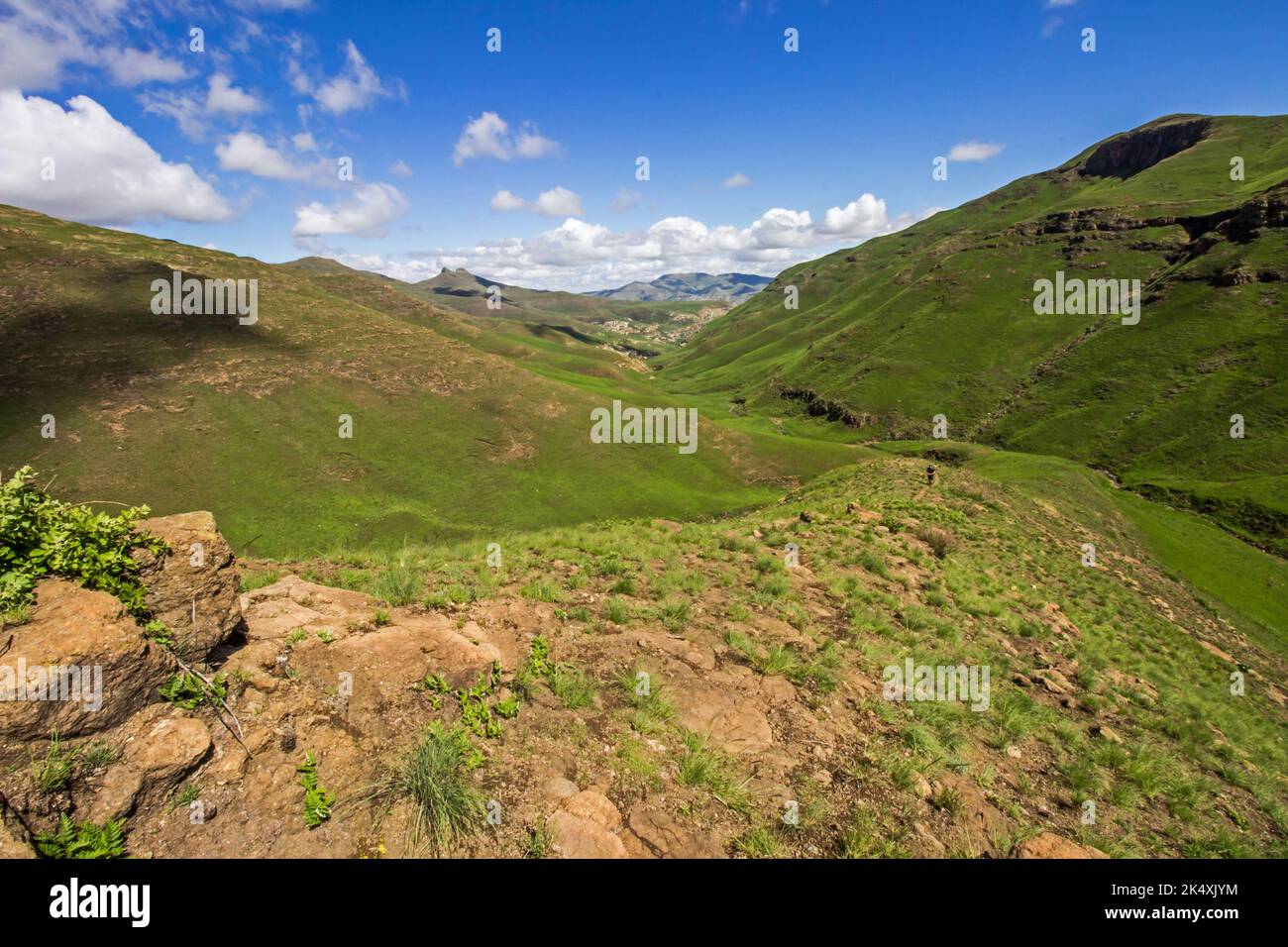 View along a grass covered ridge in the Drakensberg Mountains of the ...