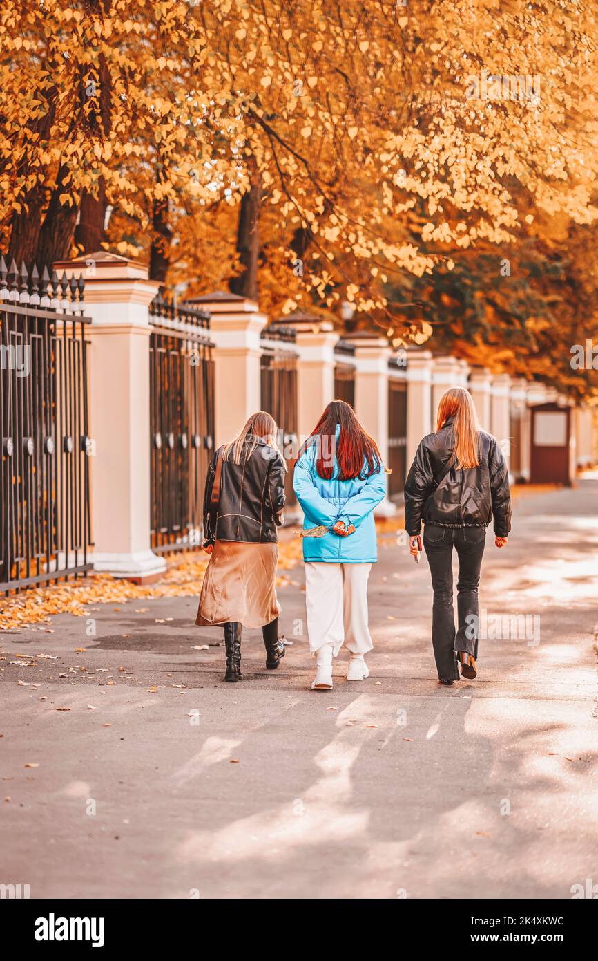 Unrecognizable girls walking in city, rear view. Regular people out in public places Stock Photo ...