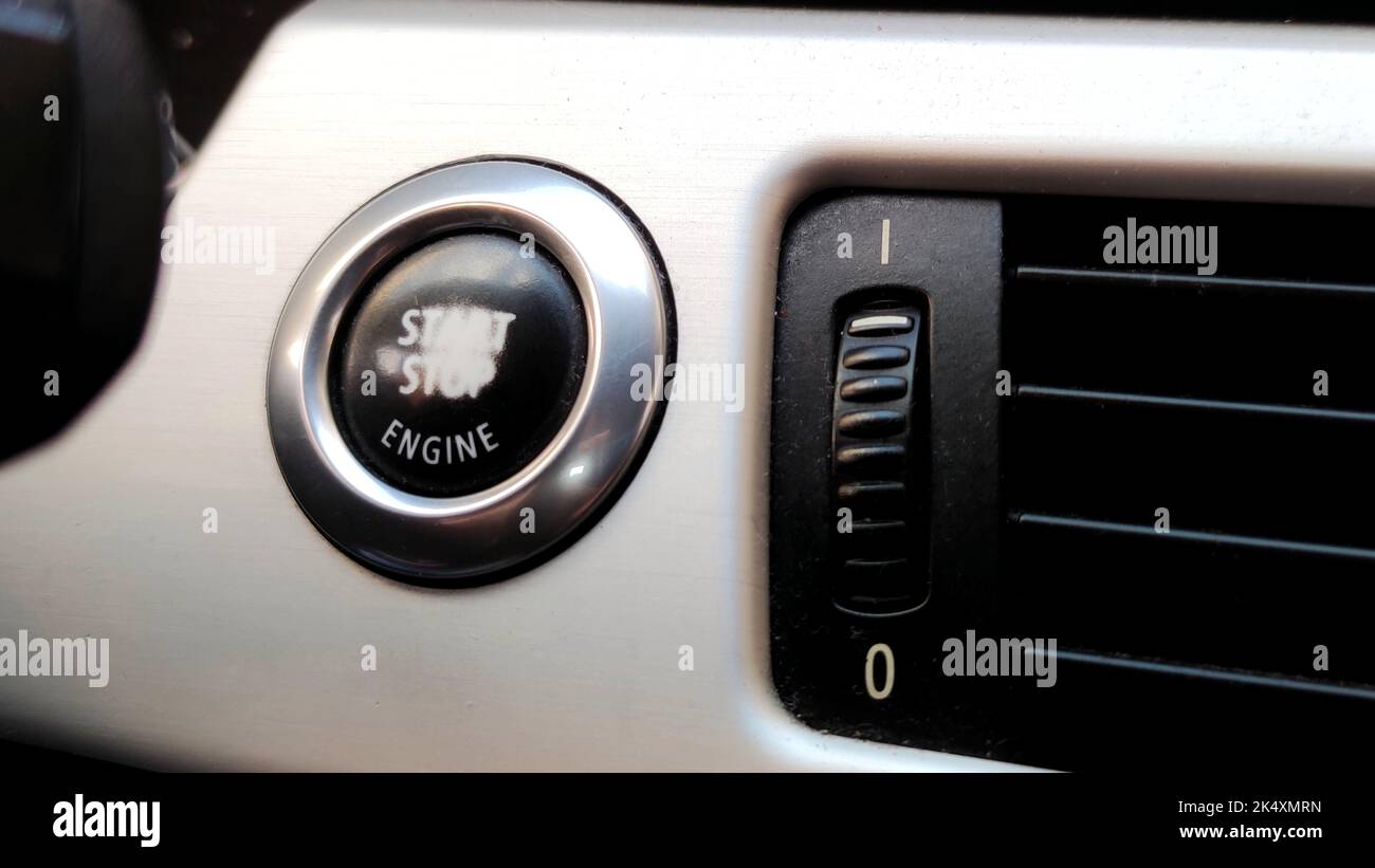 Car engine start button black and white close-up with blurred ...