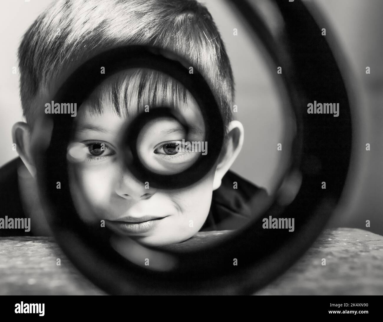 young boy photographed through a spiral Stock Photo - Alamy
