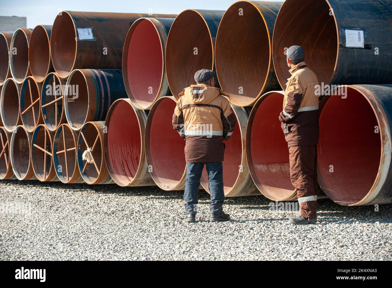 A Line of oilfield large streel pipes in industrial construction area ...