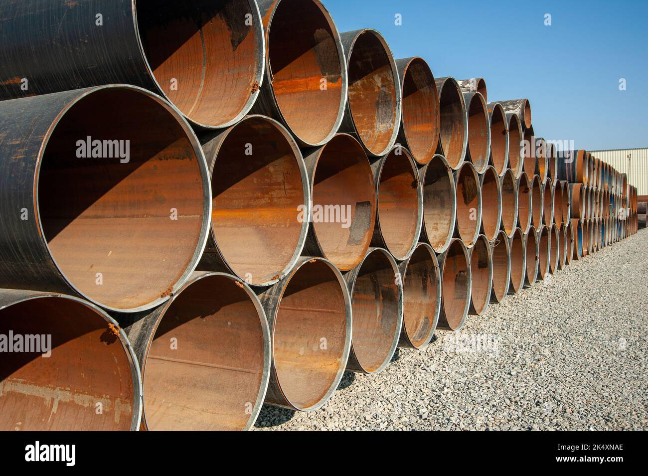 A Line of oilfield large streel pipes in industrial construction area ...