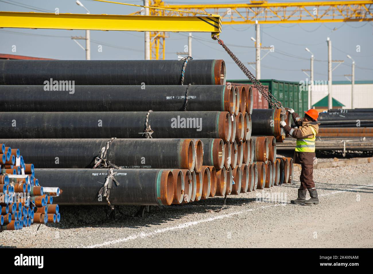 A Line of oilfield large streel pipes in industrial construction area ...