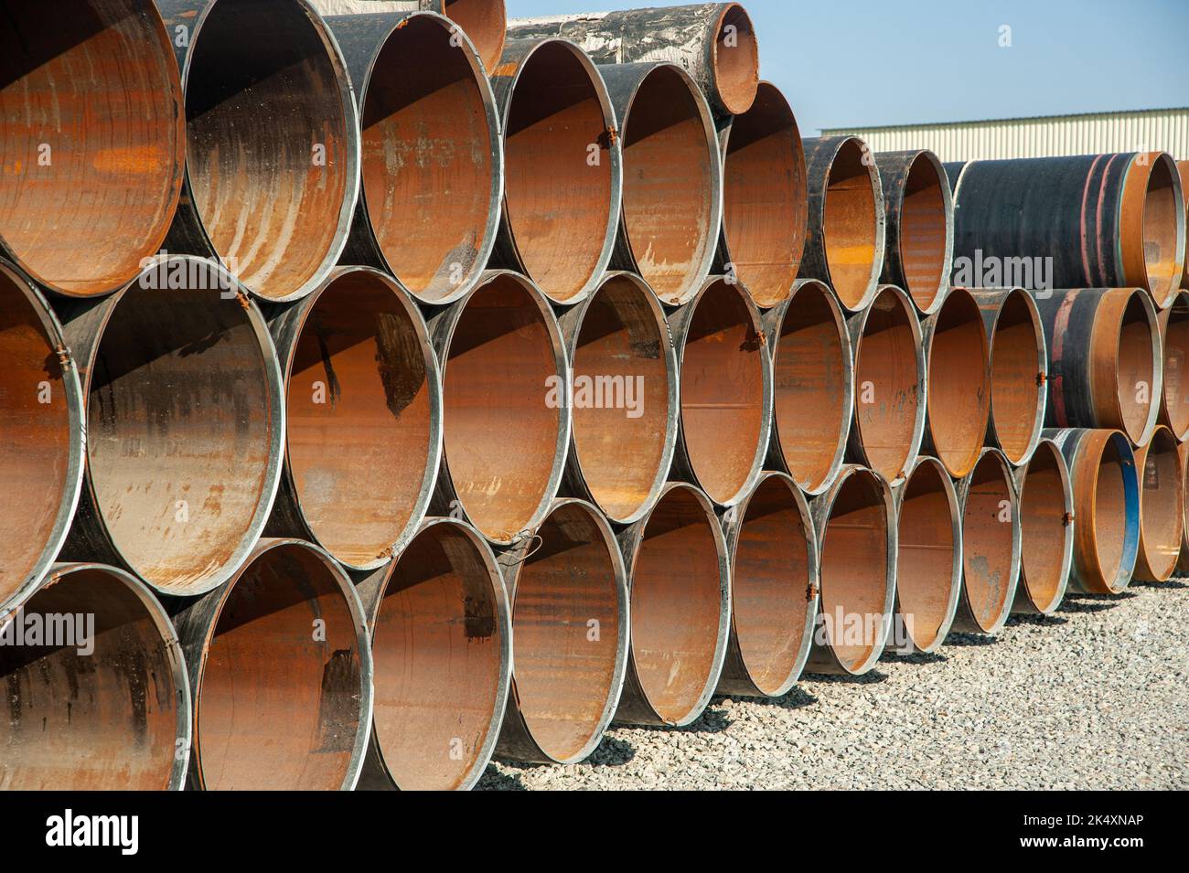 Lines of oilfield large streel pipes in an industrial construction area ...