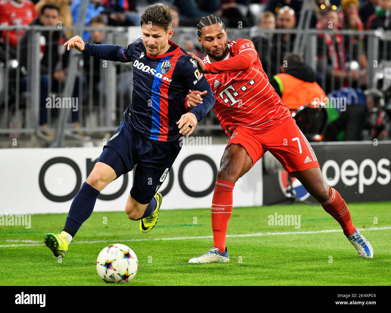 Munich, Germany. 04th Oct, 2022. Vaclav Pilar of Plzen, left, and Serge Gnabry of Bayern in ...