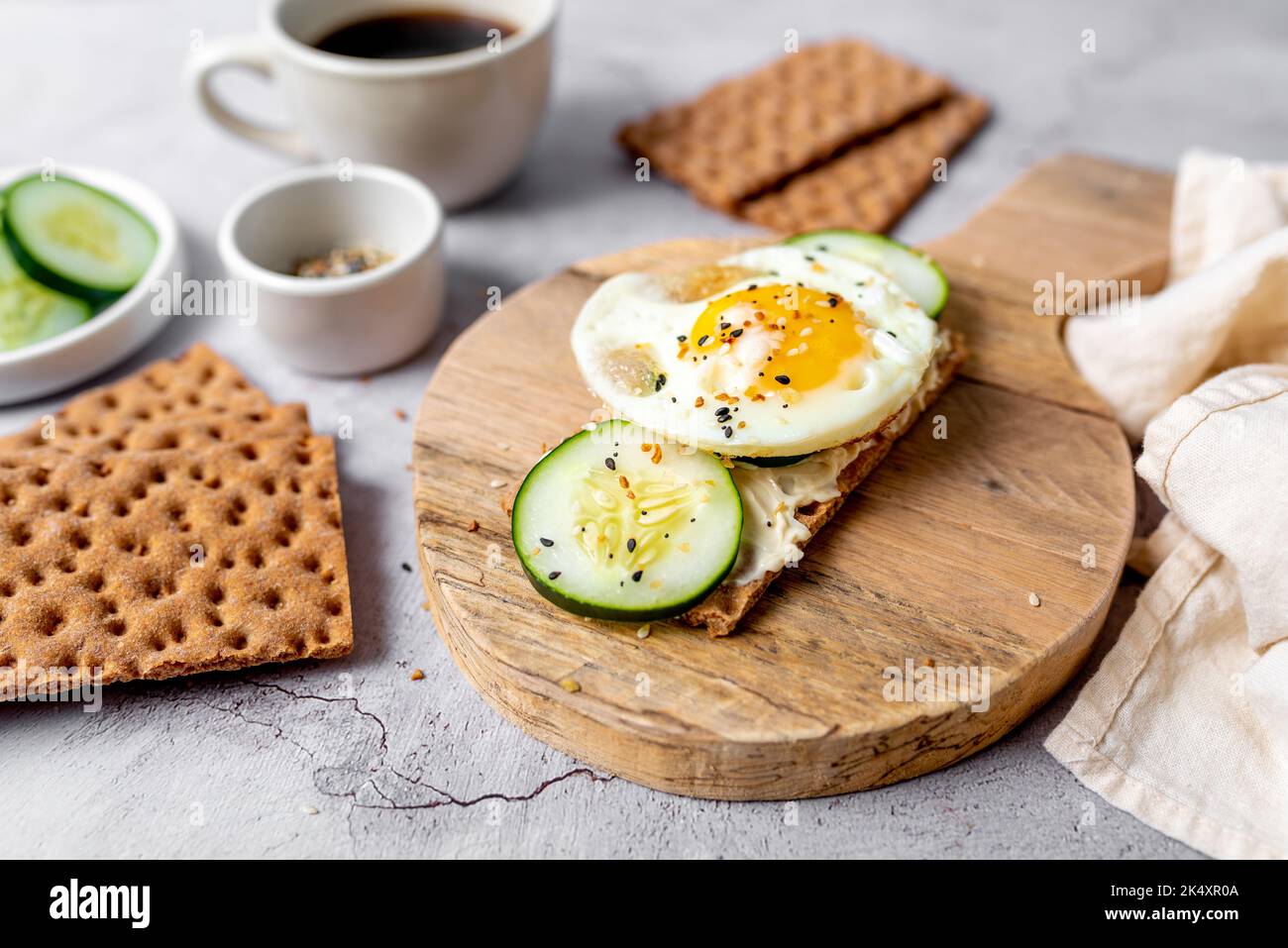 Healthy crispbread breakfast. Whole wheat with cream cheese, cucumbers ...