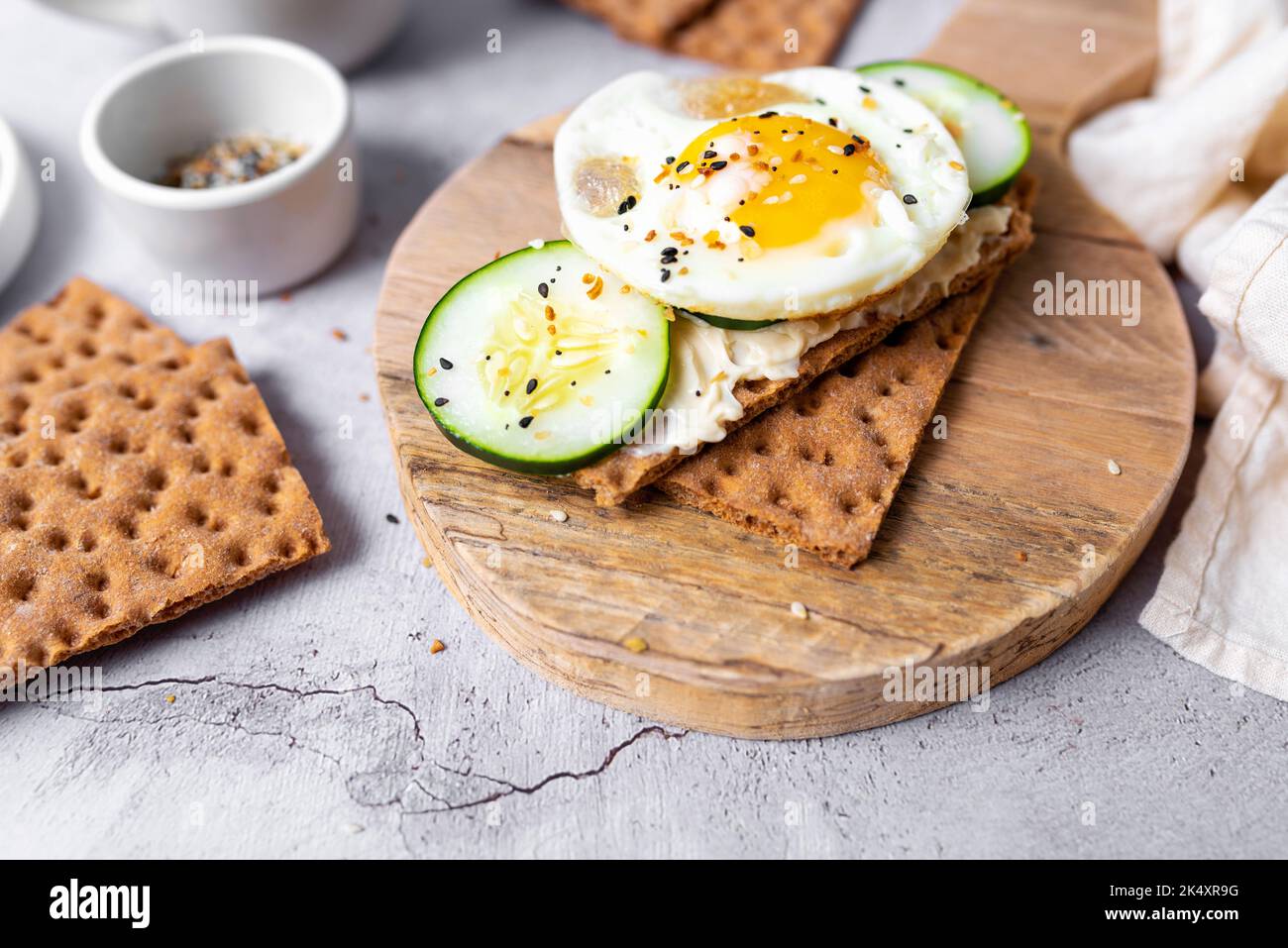 Healthy crispbread breakfast. Whole wheat with cream cheese, cucumbers ...