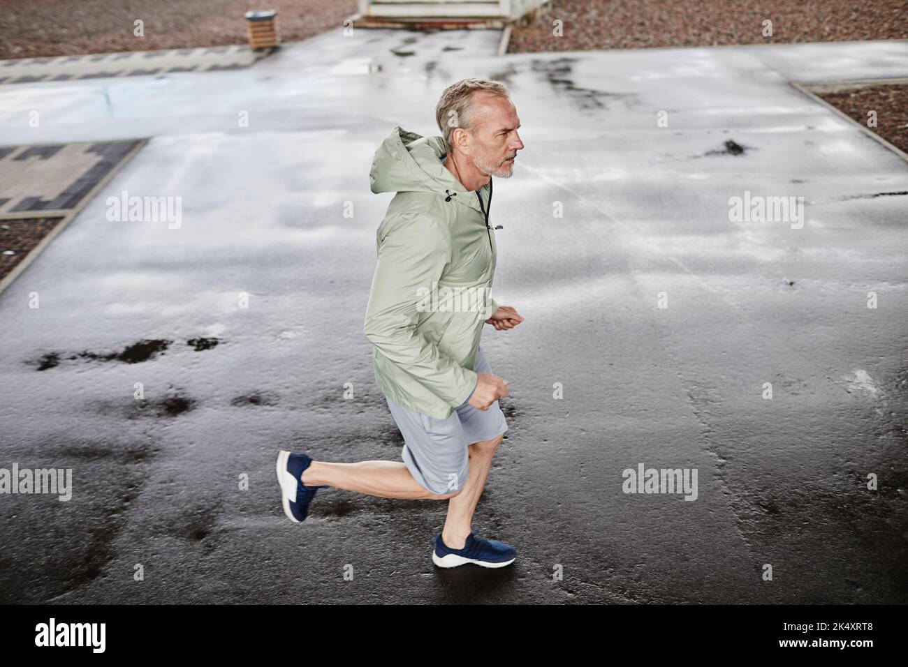 Full length portrait of senior man running outdoors in urban city ...