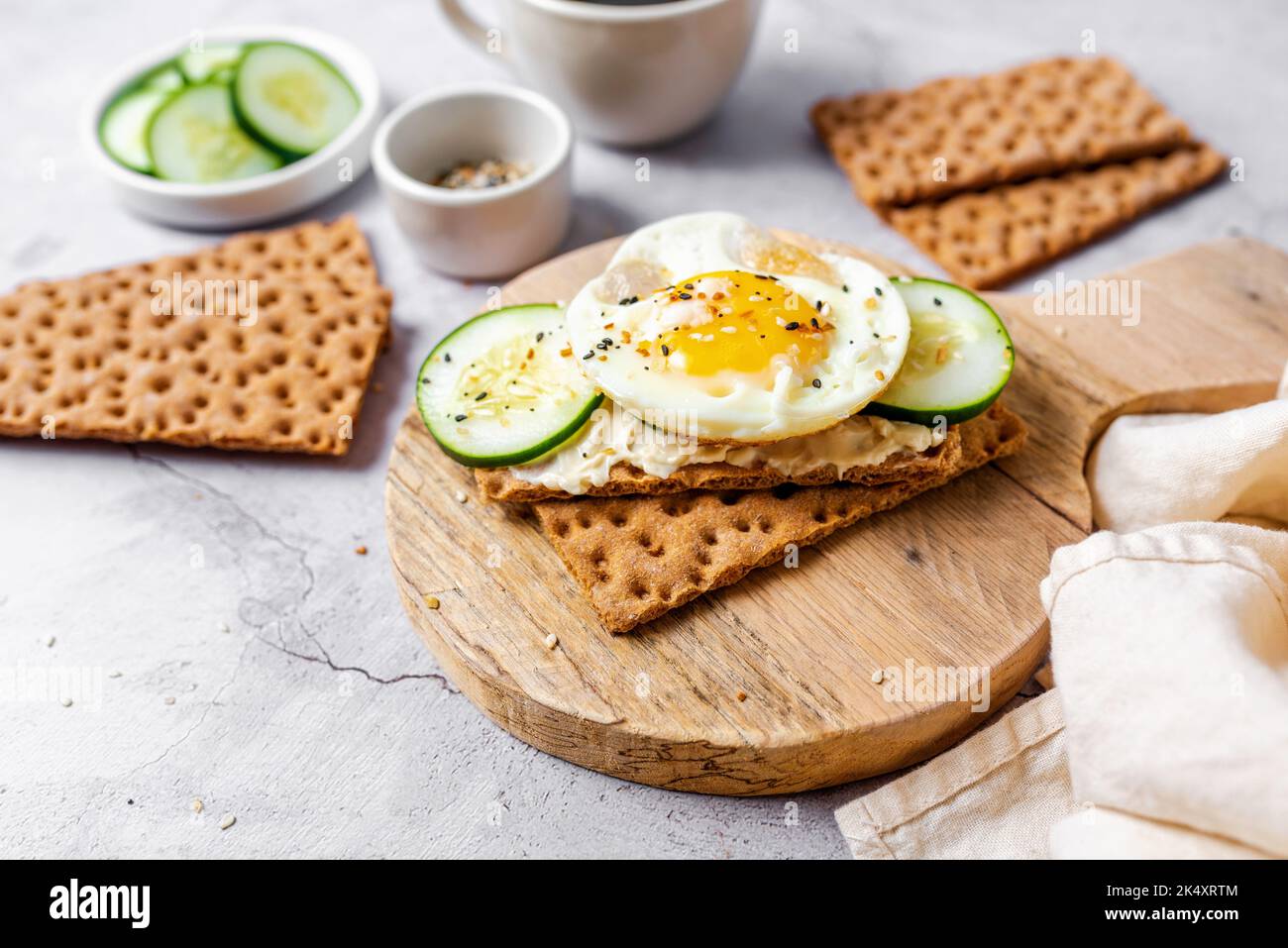Healthy crispbread breakfast. Whole wheat with cream cheese, cucumbers ...