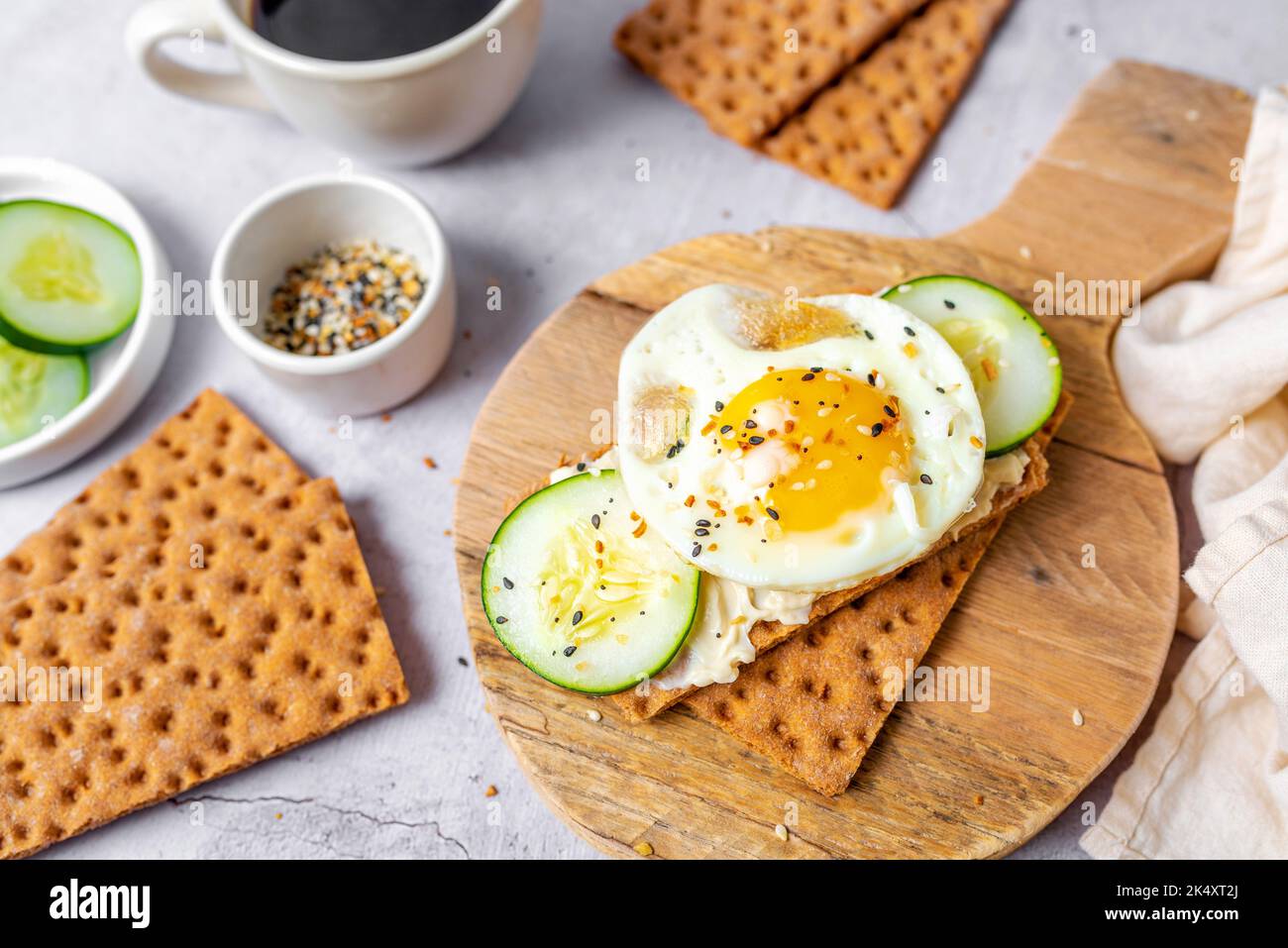 Healthy crispbread breakfast. Whole wheat with cream cheese, cucumbers ...