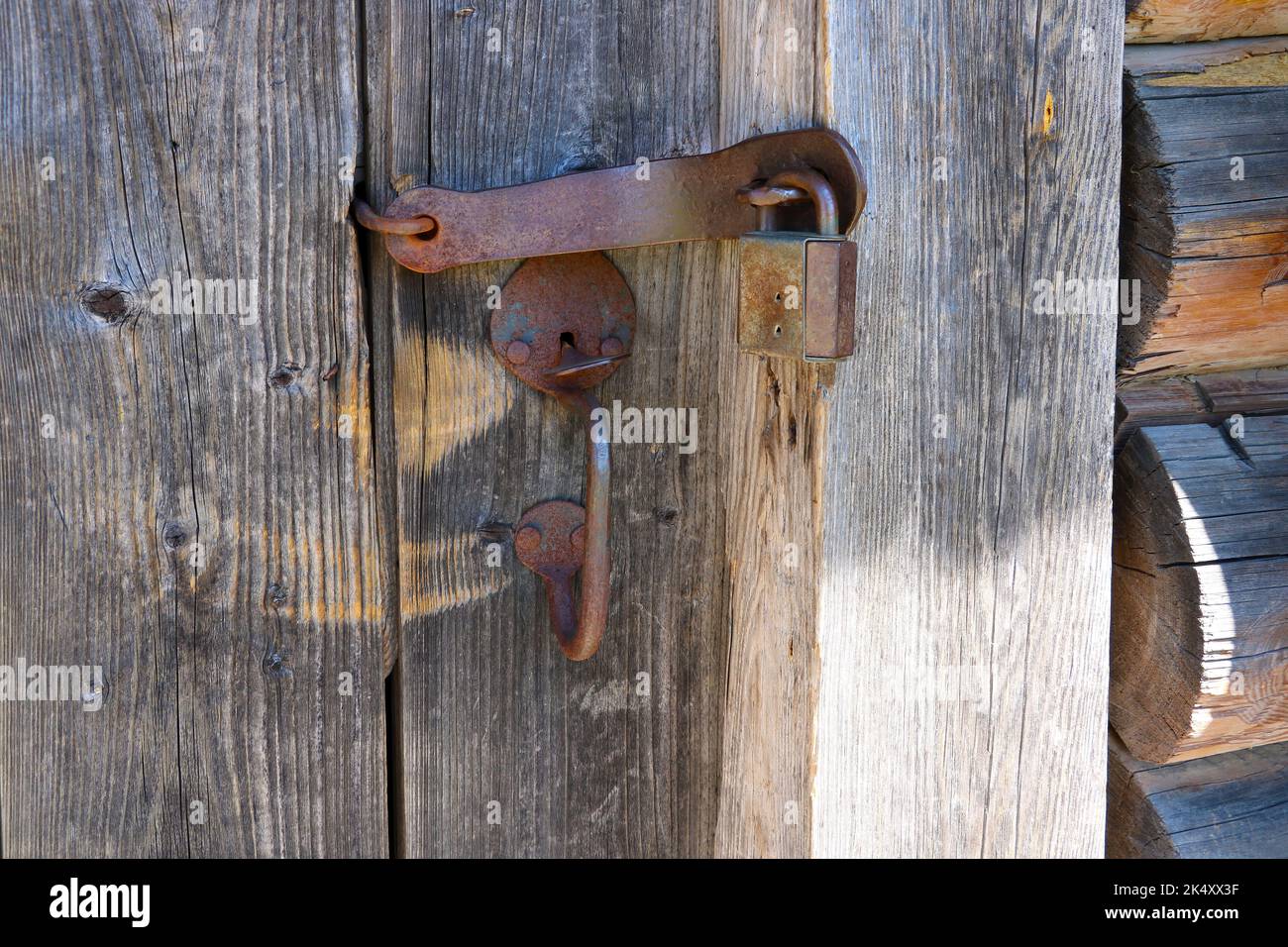 An old rusty lock and iron door handle of a wooden house Stock Photo ...
