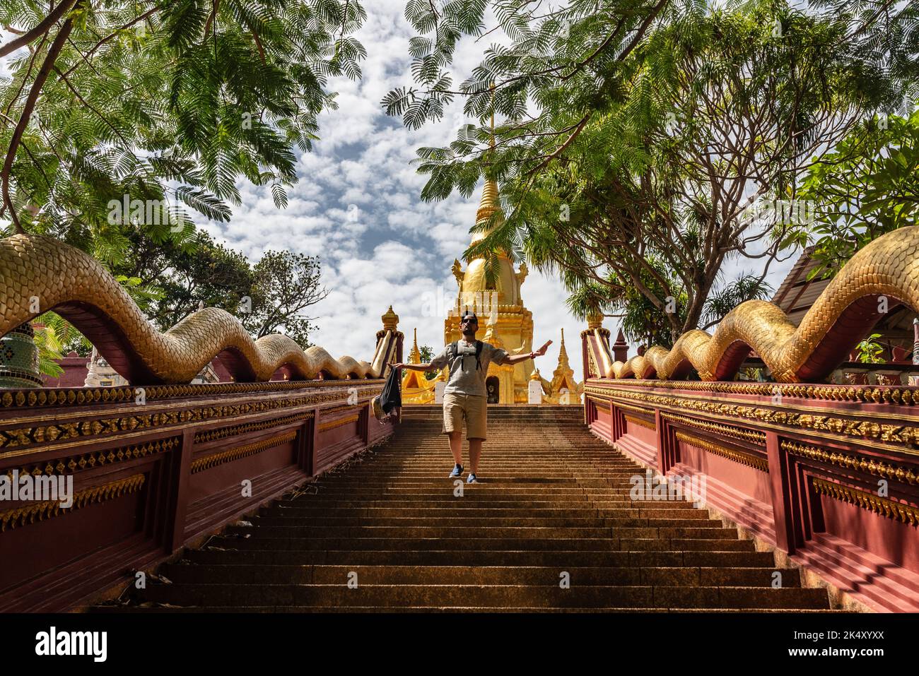 Man descending stairs with snake railing to Wat Sila Ngu temple, Jaidee ...