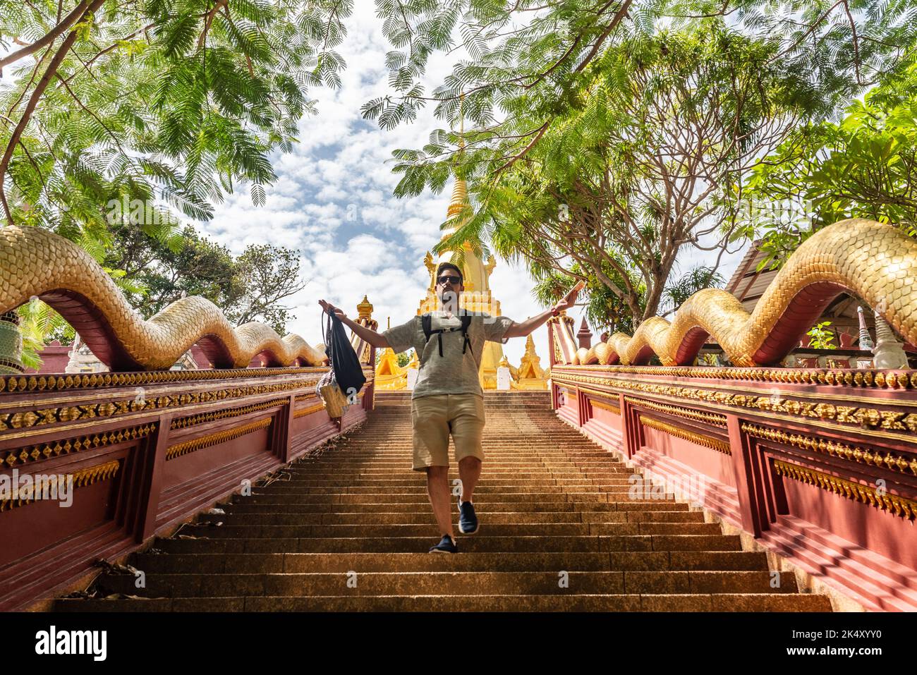 Man descending stairs with snake railing to Wat Sila Ngu temple, Jaidee ...