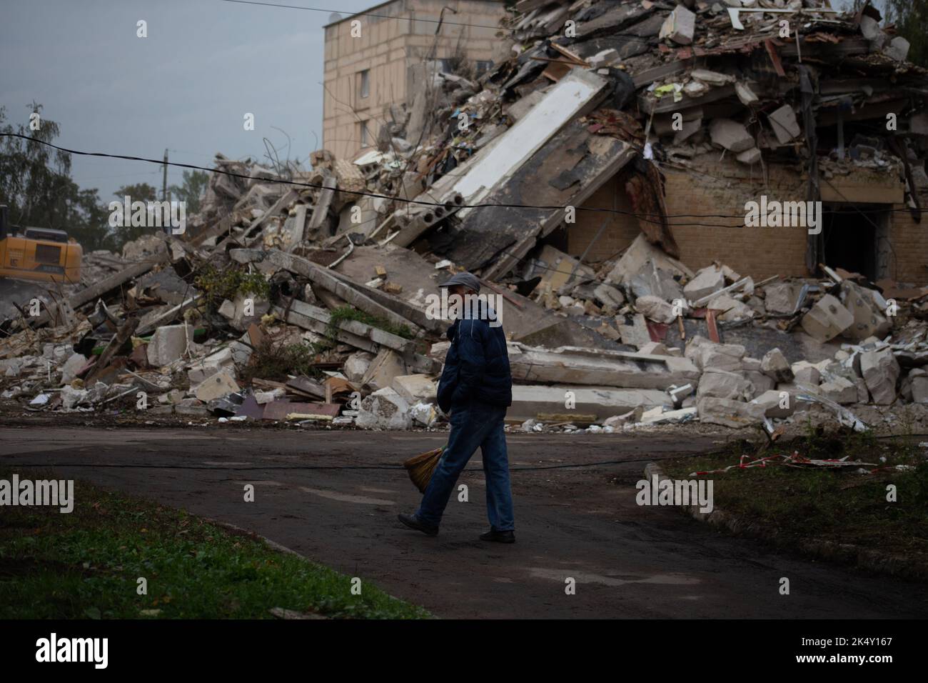 Gostomel, Ukraine 2022: Man with brooms in a ruined city Stock Photo ...