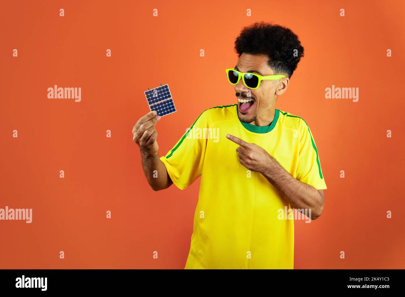Soccer Player - Black Man Celebrating Holding Solar Photovoltaic Panel ...